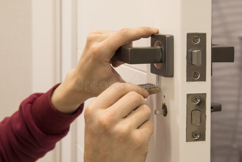Carpenter Installing the Lock on the Door Installation of the Door Lock ...