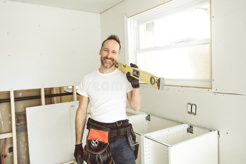 Carpenter Installing Luxury Modern Fitted Kitchen in House Stock Image ...