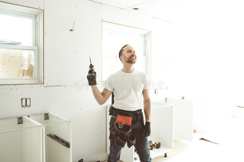 Carpenter Installing Luxury Modern Fitted Kitchen in House Stock Image ...