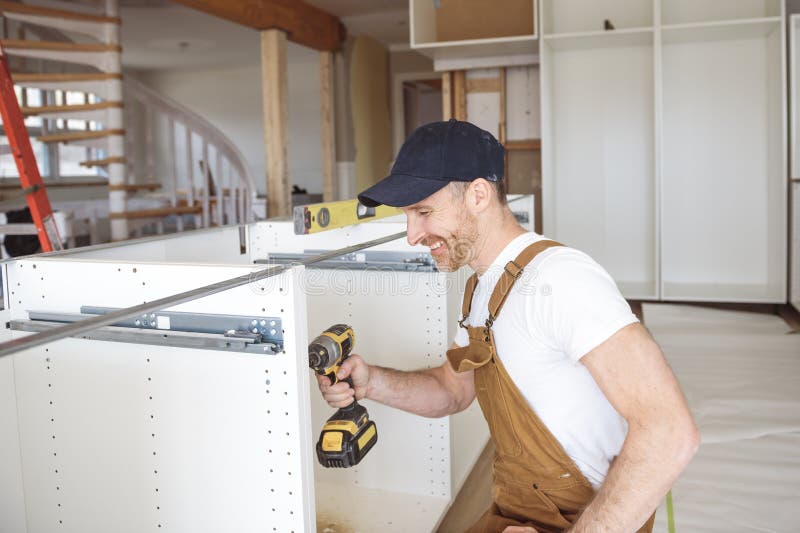 Carpenter Installing Luxury Modern Fitted Kitchen in House Stock Photo ...