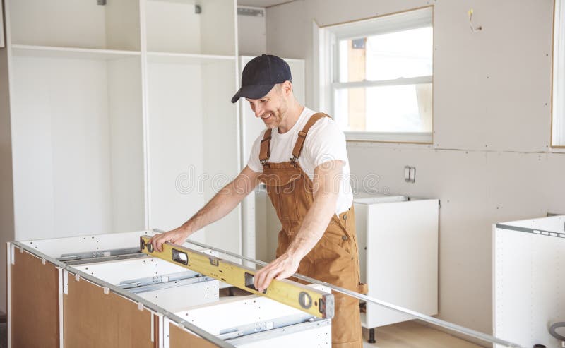 Carpenter Installing Luxury Modern Fitted Kitchen in House Stock Image ...