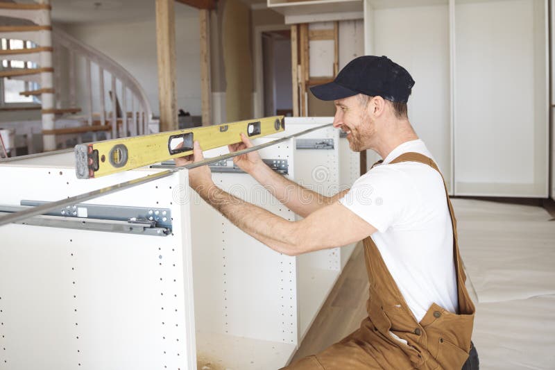 Carpenter Installing Luxury Modern Fitted Kitchen in House Stock Photo ...