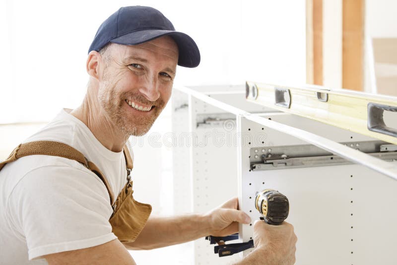 Carpenter Installing Luxury Modern Fitted Kitchen in House Stock Image ...