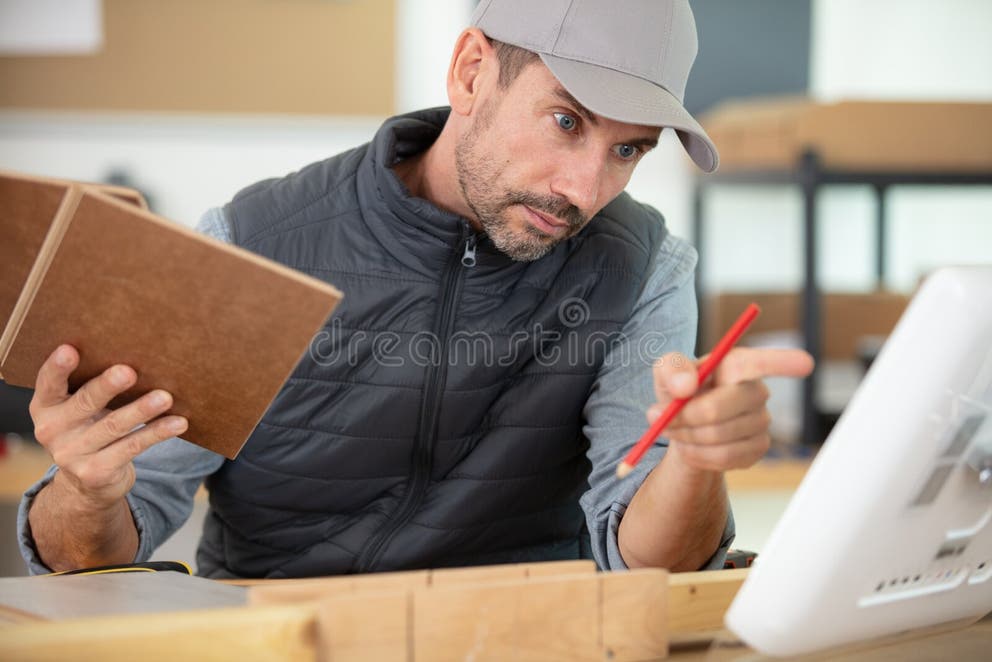 Carpenter Looking at Computer Screen Stock Photo - Image of connection, horizontal: 268033954