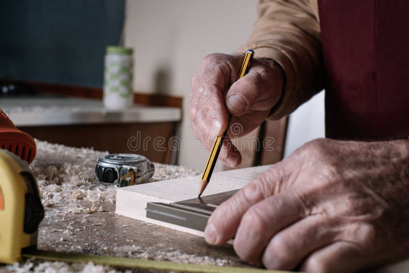 Carpenter Making Measurements on a Table with a Pencil and a Metal ...