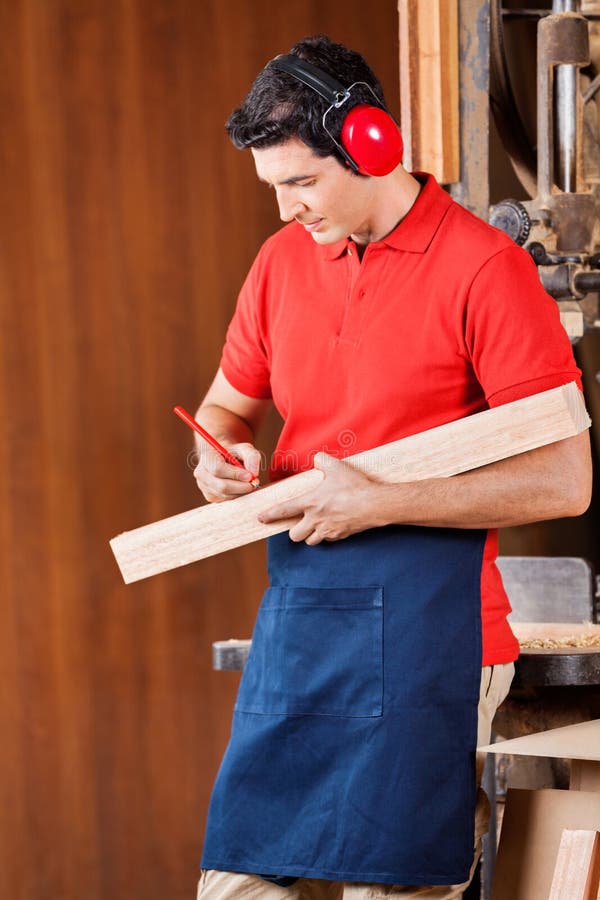 Carpenter Marking Straight Line on Plywood Sheet Using Spirit Level in ...