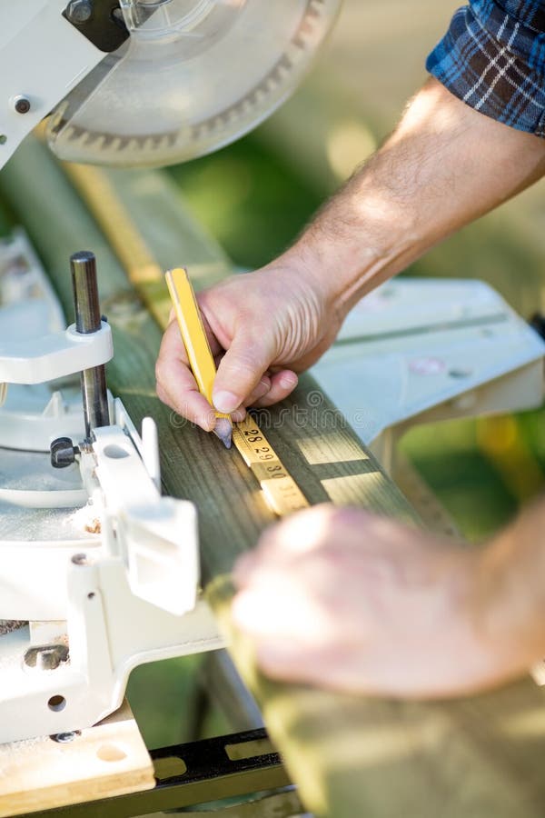 Carpenter Marking on Wood Using Ruler at Table Saw Stock Image - Image ...