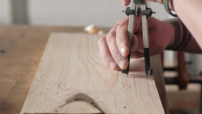 A Carpenter Marks a Pine Wooden Plank with a Compass. Woodworker Using ...