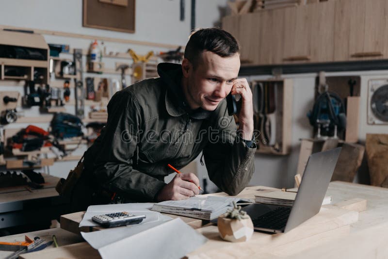 Carpenter Master is Phoning with the Smartphone in His Carpentry ...
