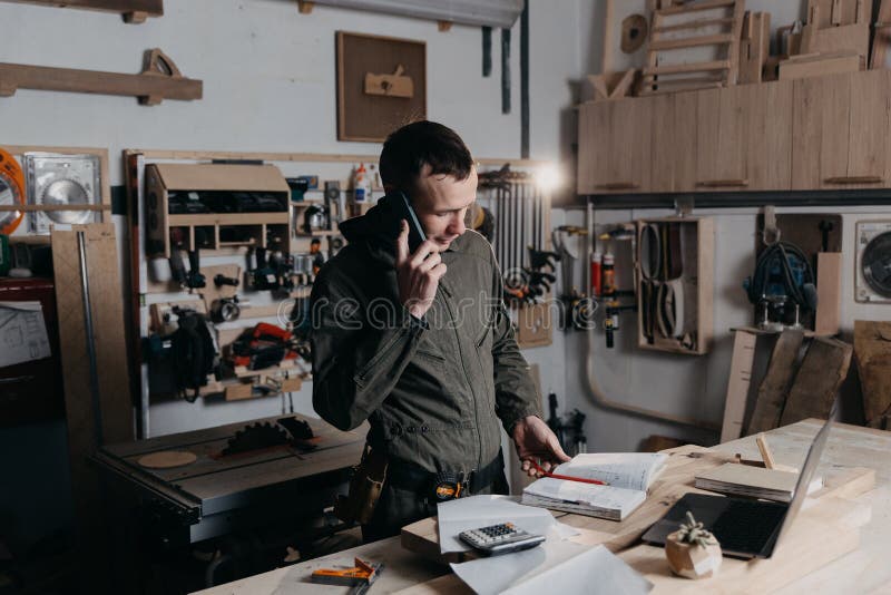 Carpenter Master is Phoning with the Smartphone in His Carpentry ...