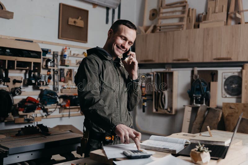 Carpenter Master is Phoning with the Smartphone in His Carpentry ...