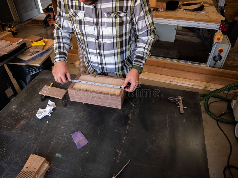 Carpenter Measuring the Box he is Building for His Current Project To ...