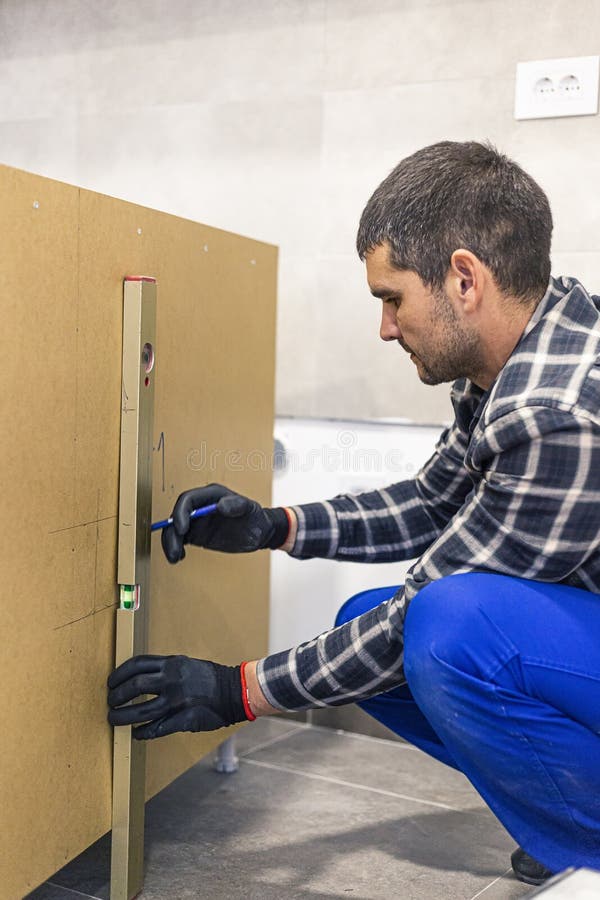 Carpenter Measuring Kitchen Shelves with a Spirit Level Stock Photo ...