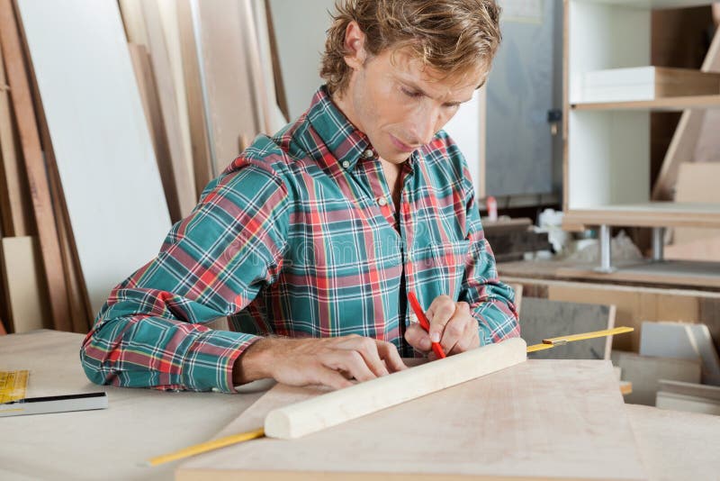 Carpenter Measuring Wood at Table Stock Photo - Image of instrument ...