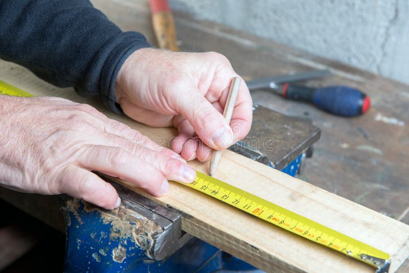 Carpenter Measuring a Wooden Board Stock Photo - Image of repair, tool ...