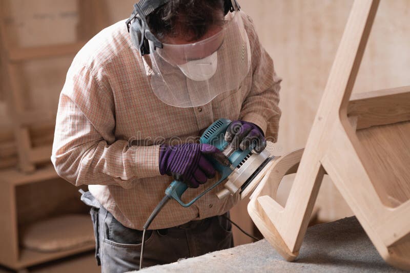Carpenter Operating with Grinder for Woodworking in a Furniture ...