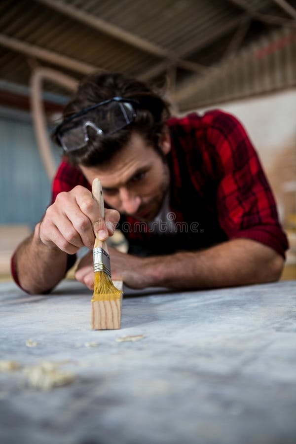 Carpenter Painting a Piece of Wood Stock Photo - Image of painting ...
