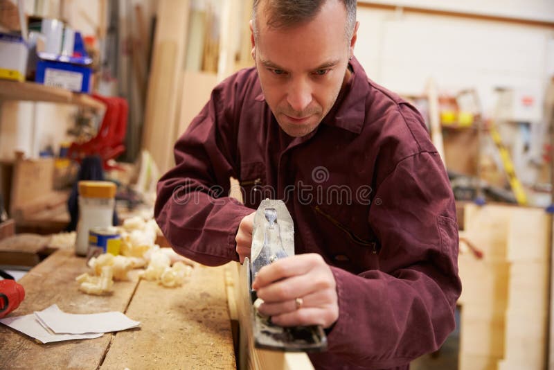 Carpenter Planing Wood in Workshop Stock Image - Image of person ...