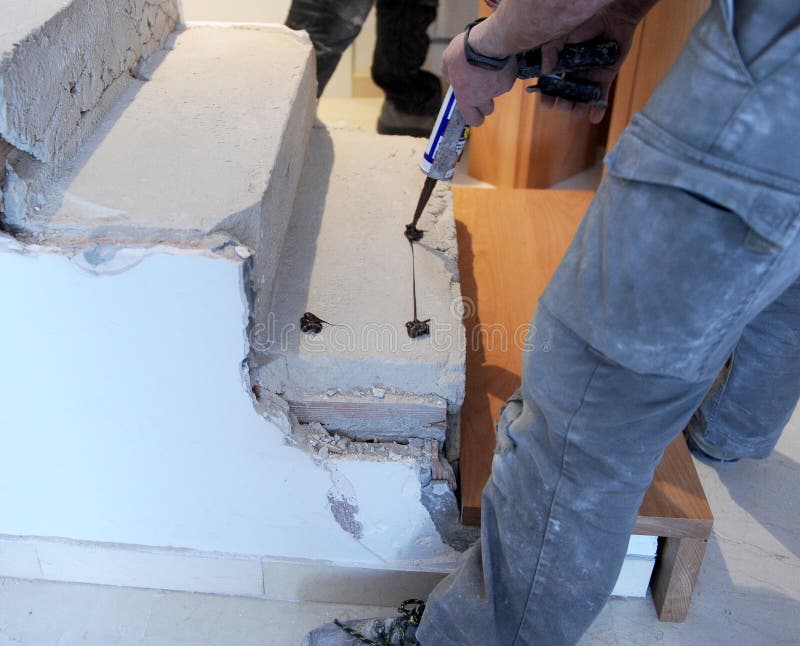 Carpenter Preparing the Concrete Steps with High Resistance Silicone To ...