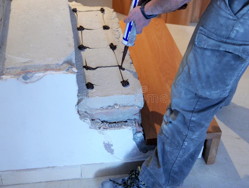 Carpenter Preparing The Concrete Steps With High Resistance Silicone To Glue The Beech Wood