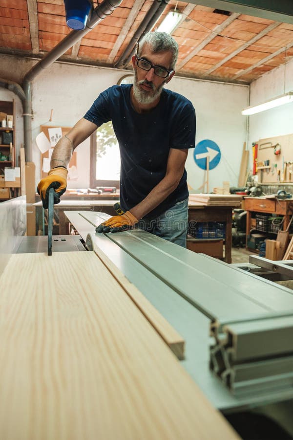 Carpenter Handling Large Pieces of Wood on an Industrial Cutting ...
