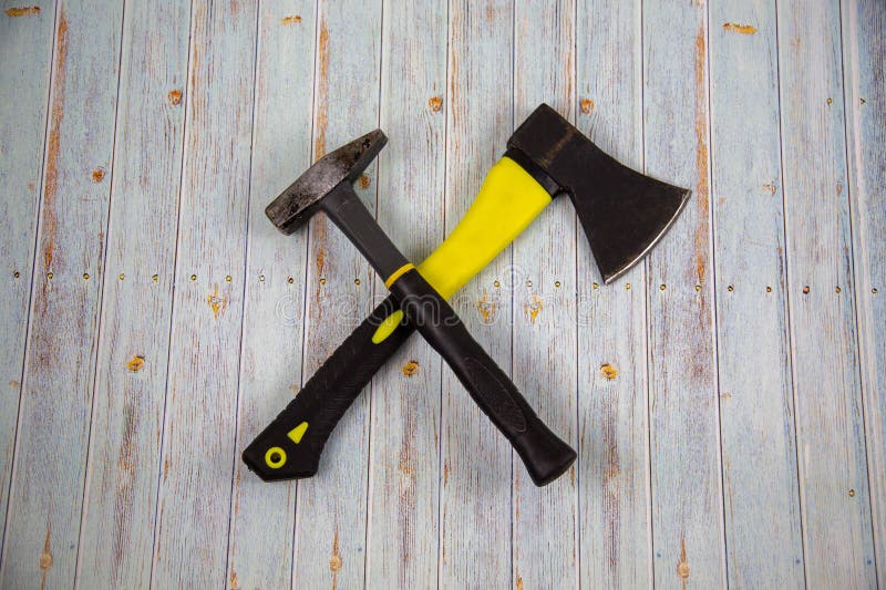 A Carpenter S Axe with a Yellow Handle and a Hammer Lying Crosswise on ...