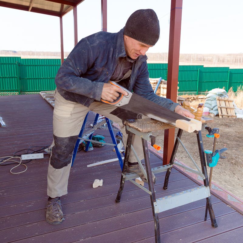 Carpenter with Saw Outdoor stock photo. Image of timber - 52304708