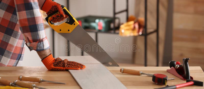 Carpenter Sawing Wooden Plank at Table in Workshop, Closeup. Banner ...