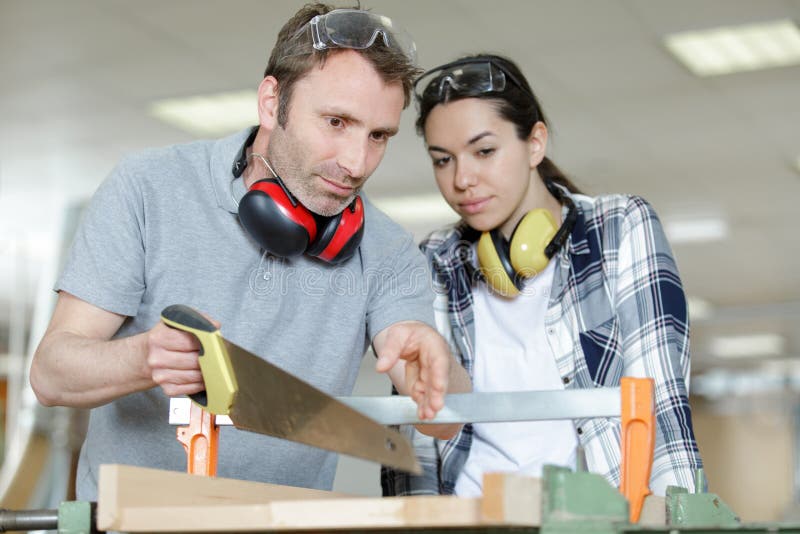 Carpenter Teaching Apprentice Cutting Wood Stock Image - Image of ...