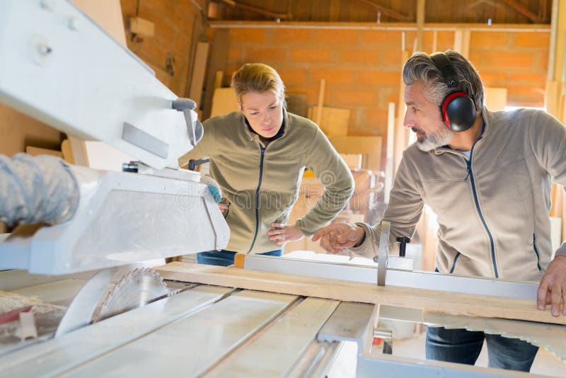 Carpenter Teaching Apprentice How To Cut Wood Stock Image - Image of ...