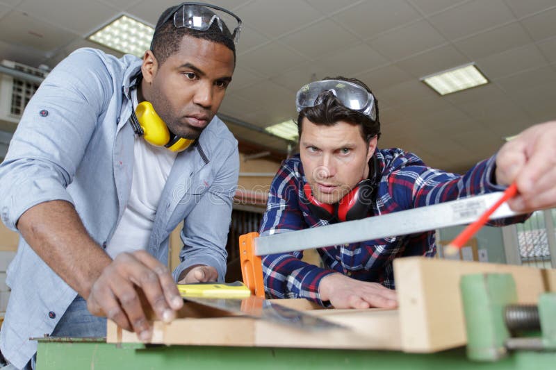 Carpenter Teaching Apprentice How To Measure Wood Stock Photo - Image ...