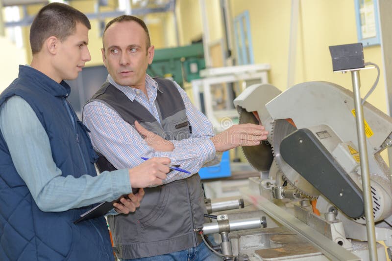 Carpenter Teaching Apprentice How To Use Circular Saw Stock Image ...