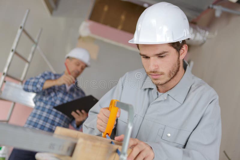 Carpenter Teaching Apprentice How To Use Circular Saw Stock Image ...