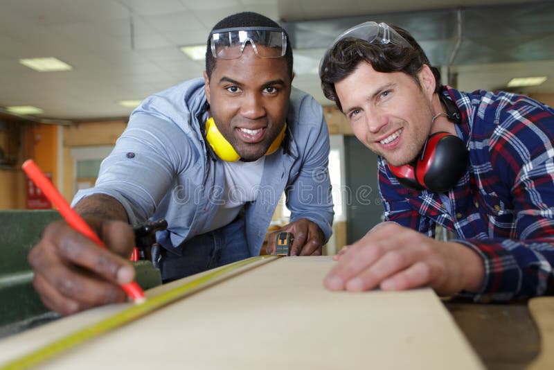 Carpenter Teaching Apprentice Standing at Table in Workshop Stock Image ...