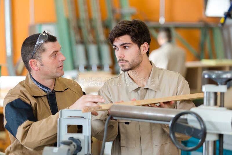 Carpenter Training Apprentice To Use Plane Stock Image - Image of ...
