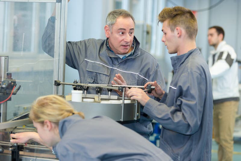 Carpenter Training Apprentices To Use Plane Stock Photo - Image of ...