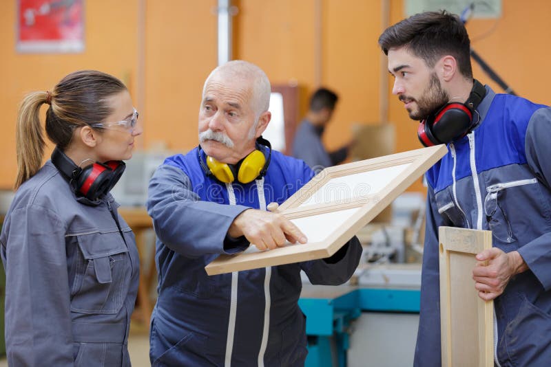 Carpenter Training Female Apprentice To Use Plane Stock Photo - Image ...