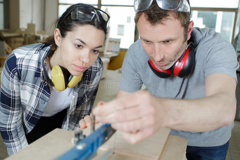 Carpenter Training Female Apprentice To Use Plane Stock Image - Image ...