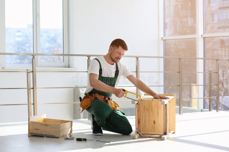 Carpenter in Uniform Making Furniture. Professional Construction Tools ...