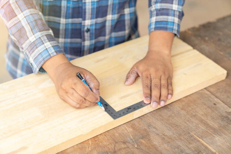 The Carpenter Use Solid Square To Measure Wood Sheet Stock Image ...