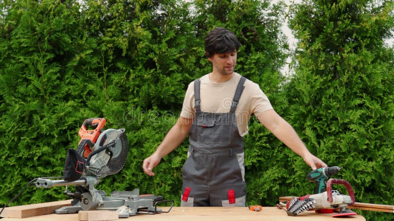 Carpenter Using Camcorder in Workshop. Caucasian Male Craftsperson with ...