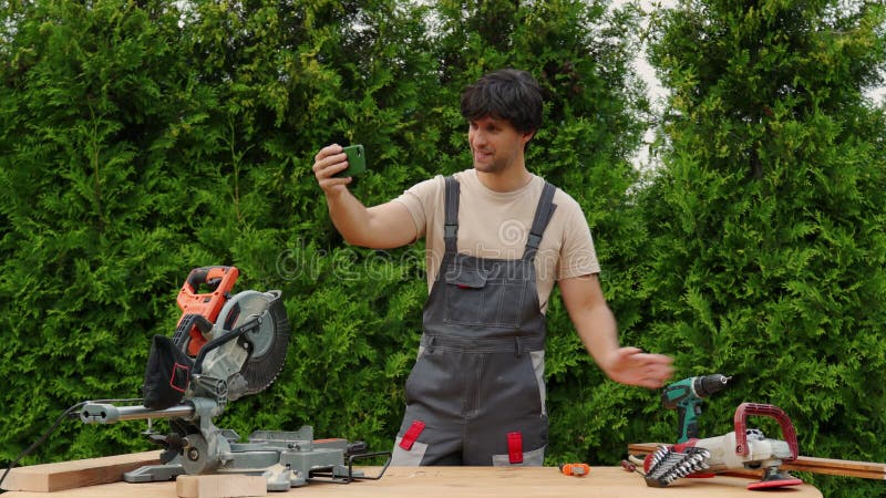 Carpenter Using Camcorder in Workshop. Caucasian Male Craftsperson with ...