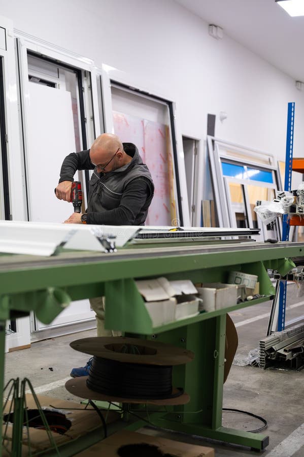 Carpenter Using Cordless Drill Assembling Aluminum Window Frame ...