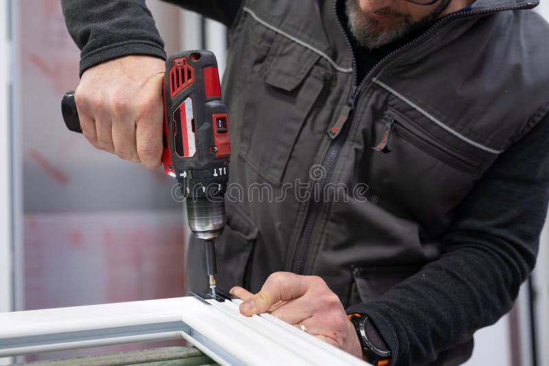 Carpenter Using Cordless Drill Assembling Aluminum Window Frame Stock ...