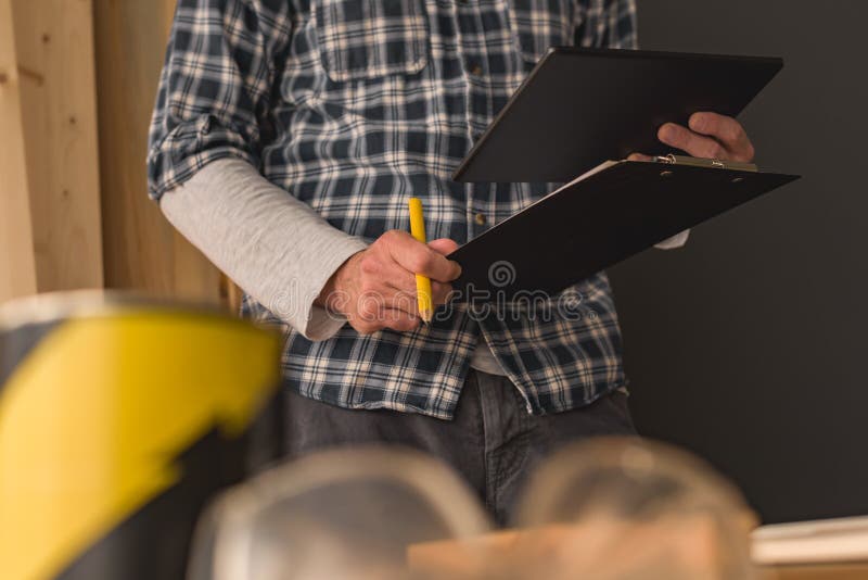 Carpenter Using Digital Tablet and Clipboard Notepad Stock Image ...