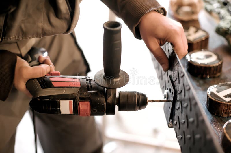Carpenter Using Electric Drill for His Job in Carpentry Workshop Stock ...