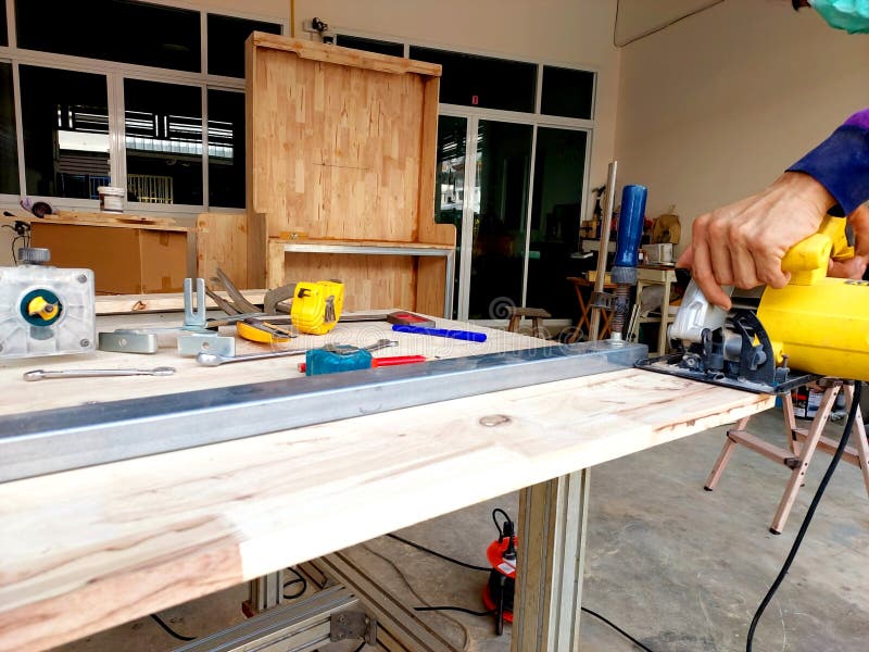 Carpenter Using Electric Hand Circular Saw Cutting Pine Wood Plank ...