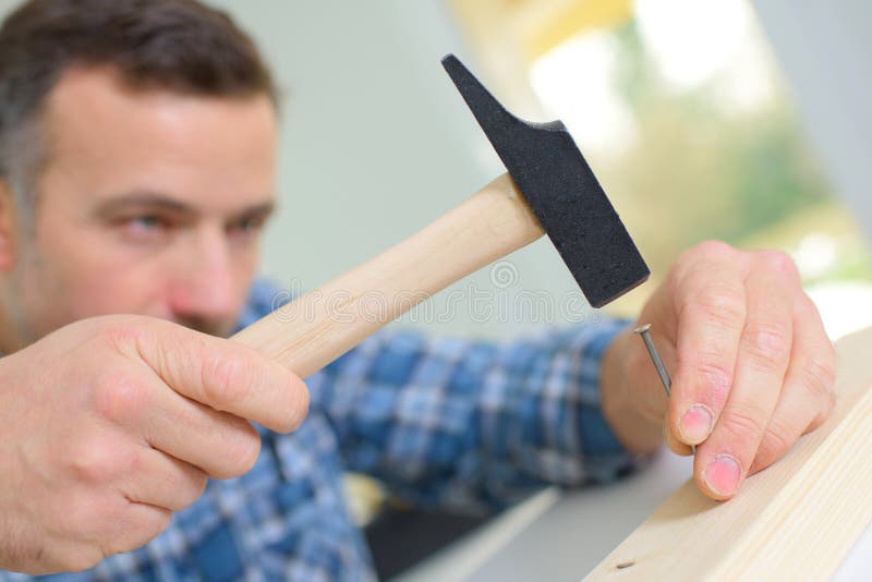 Carpenter using a hammer stock photo. Image of occupation - 121666656