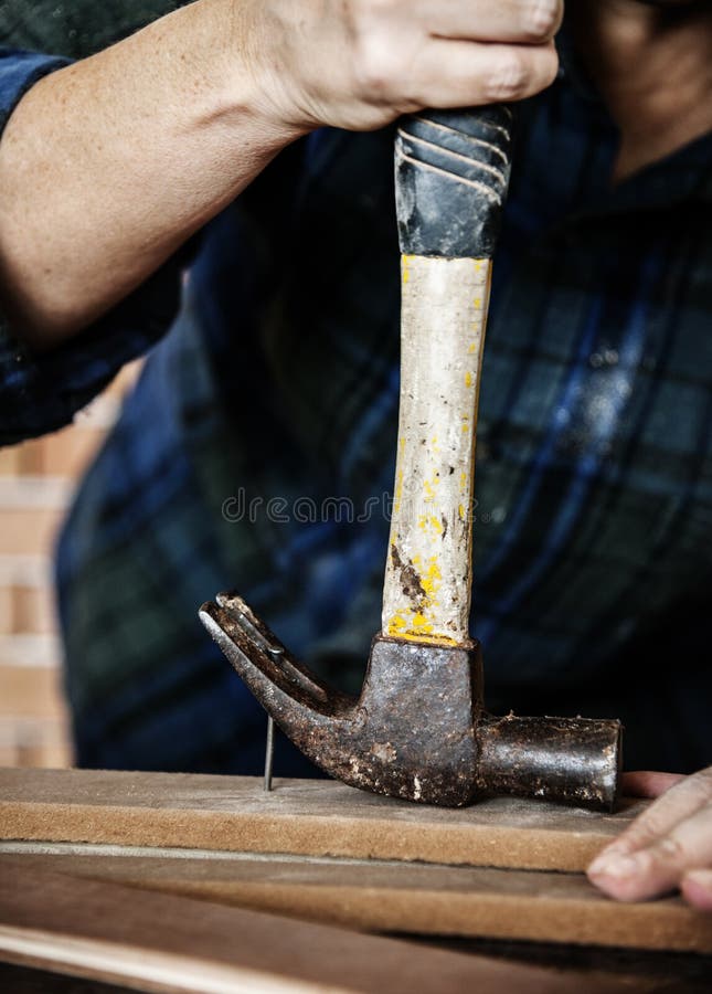 Carpenter Using Hammer Pull a Nail Out from a Wood Stock Image - Image ...