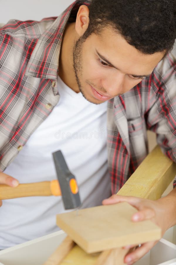 Carpenter Using Hammer on Wood Stock Image - Image of focused, casual ...